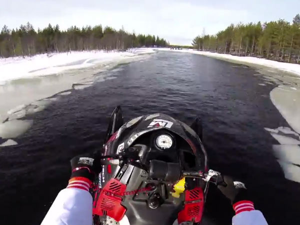 Snowmobile Wheelies Across A River - DriveSpark